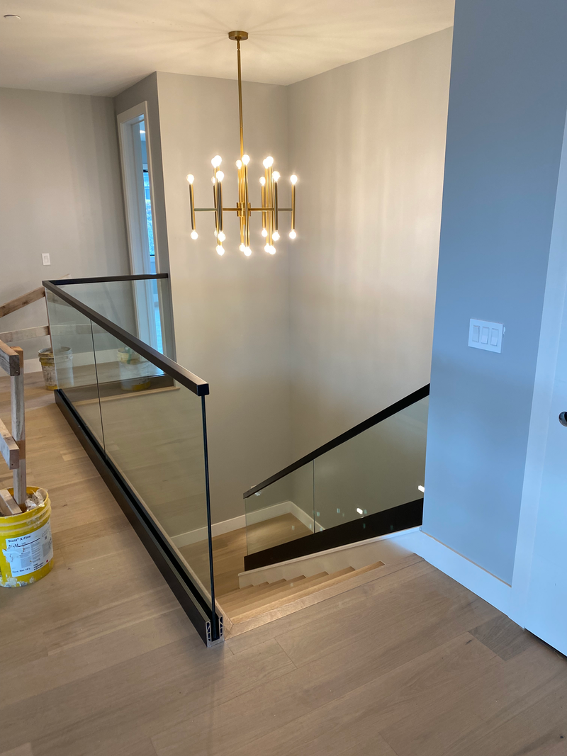 Glass railing in base shoe mount. Matte Black Finish. - Integrity Glass