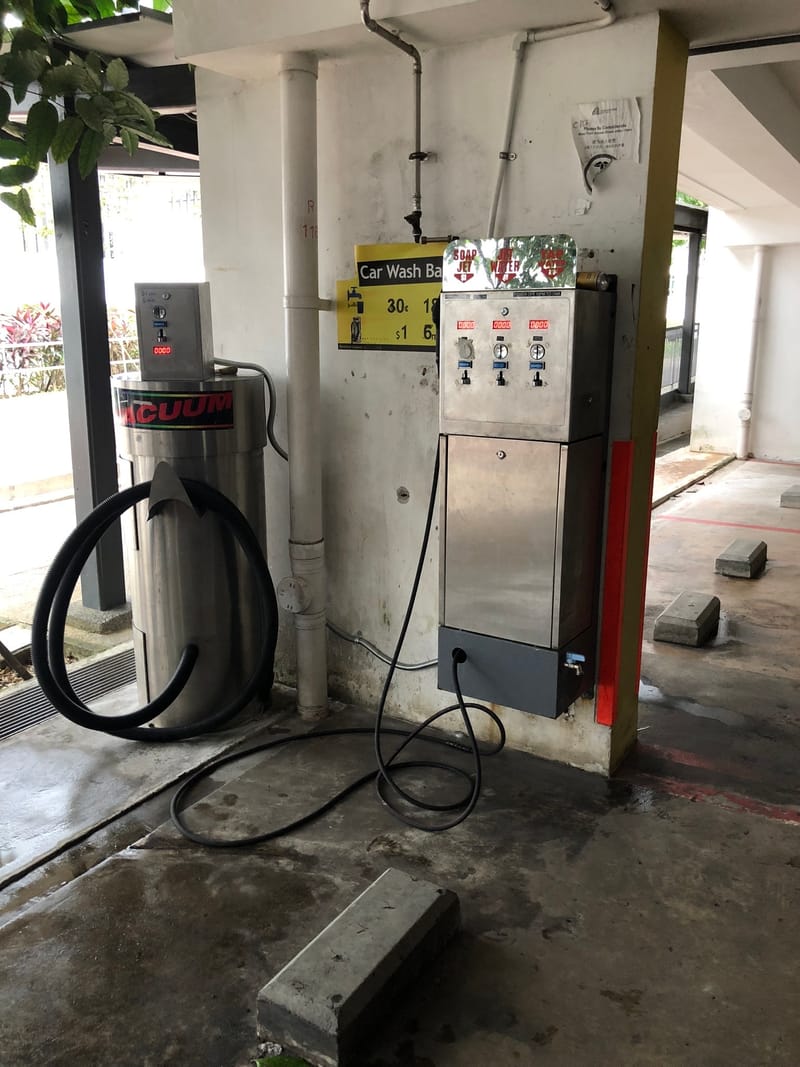 coin operated water dispenser at hdb car park washing bay,